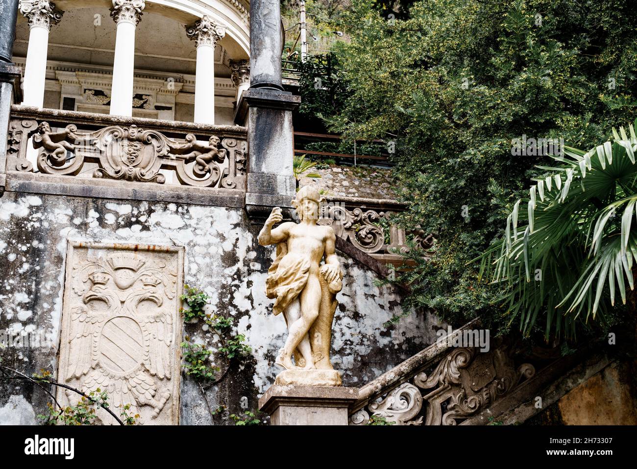 Stone statue near the pillar terrace in Villa Monastero. Lake Como ...
