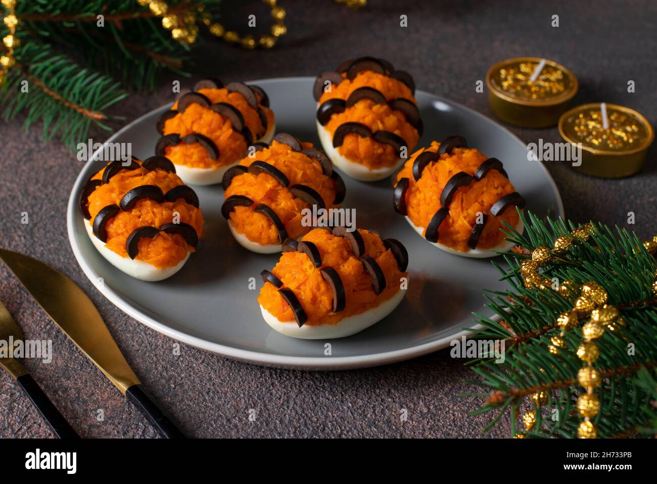 Tiger appetizer made of stuffed eggs with cod liver and carrot for New ...