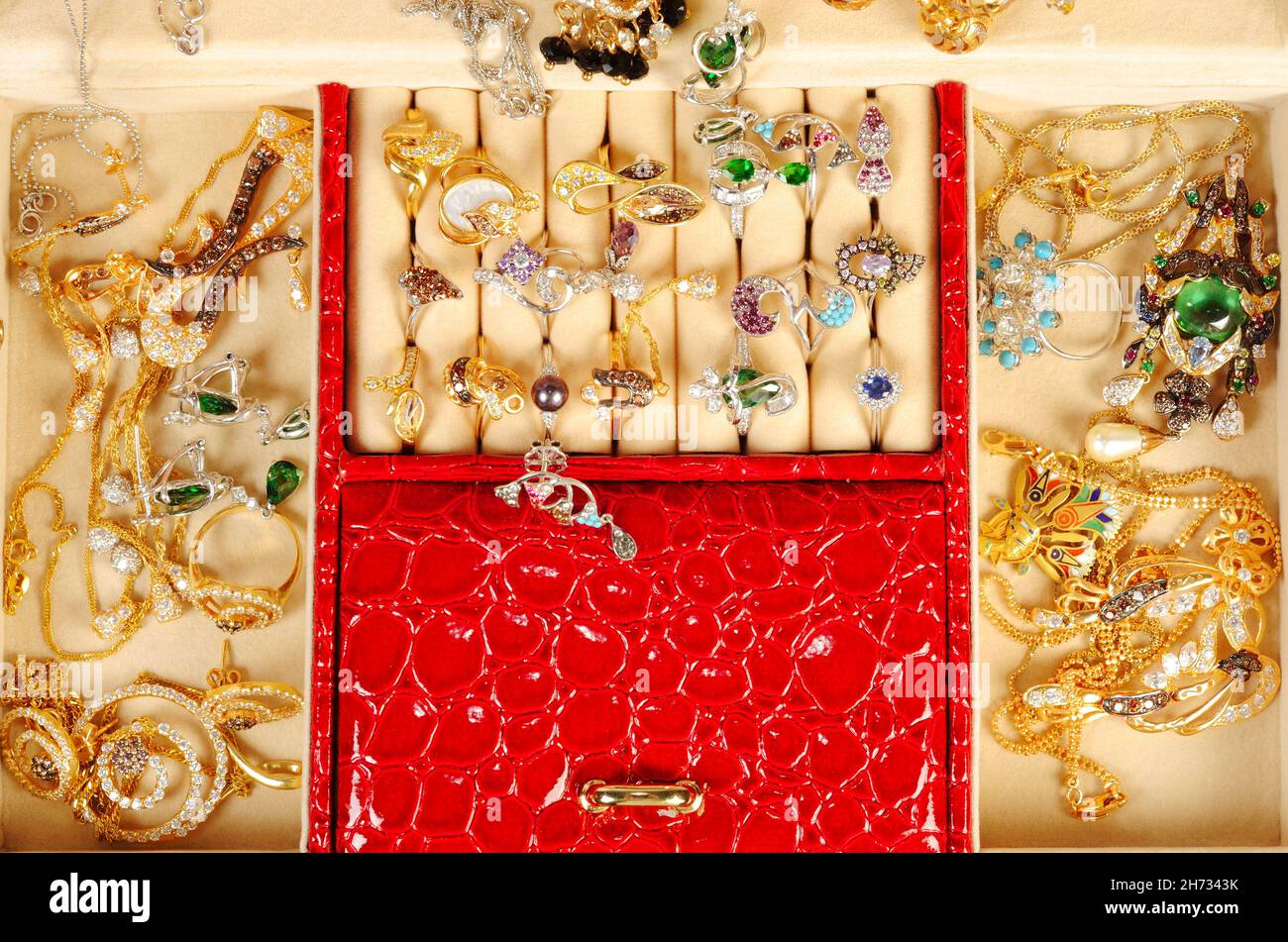An open jewlery box with gold and platinum jewelry and accessory close ...
