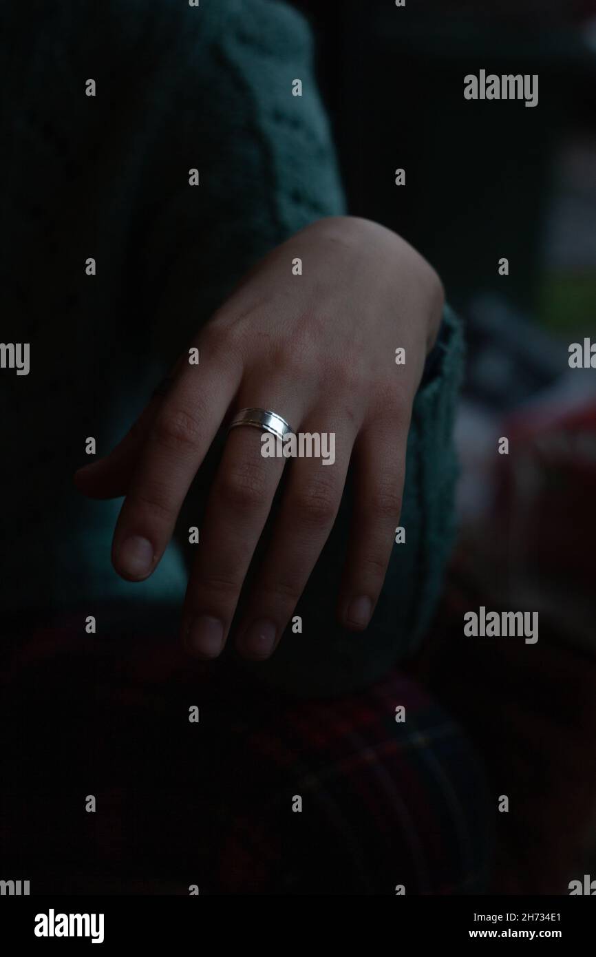 Close-up shot of a female hand with ring on her middle finger on a ...