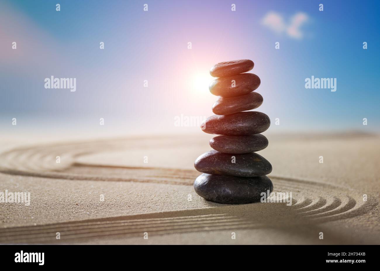 Zen garden with stacked stones on sand Stock Photo - Alamy