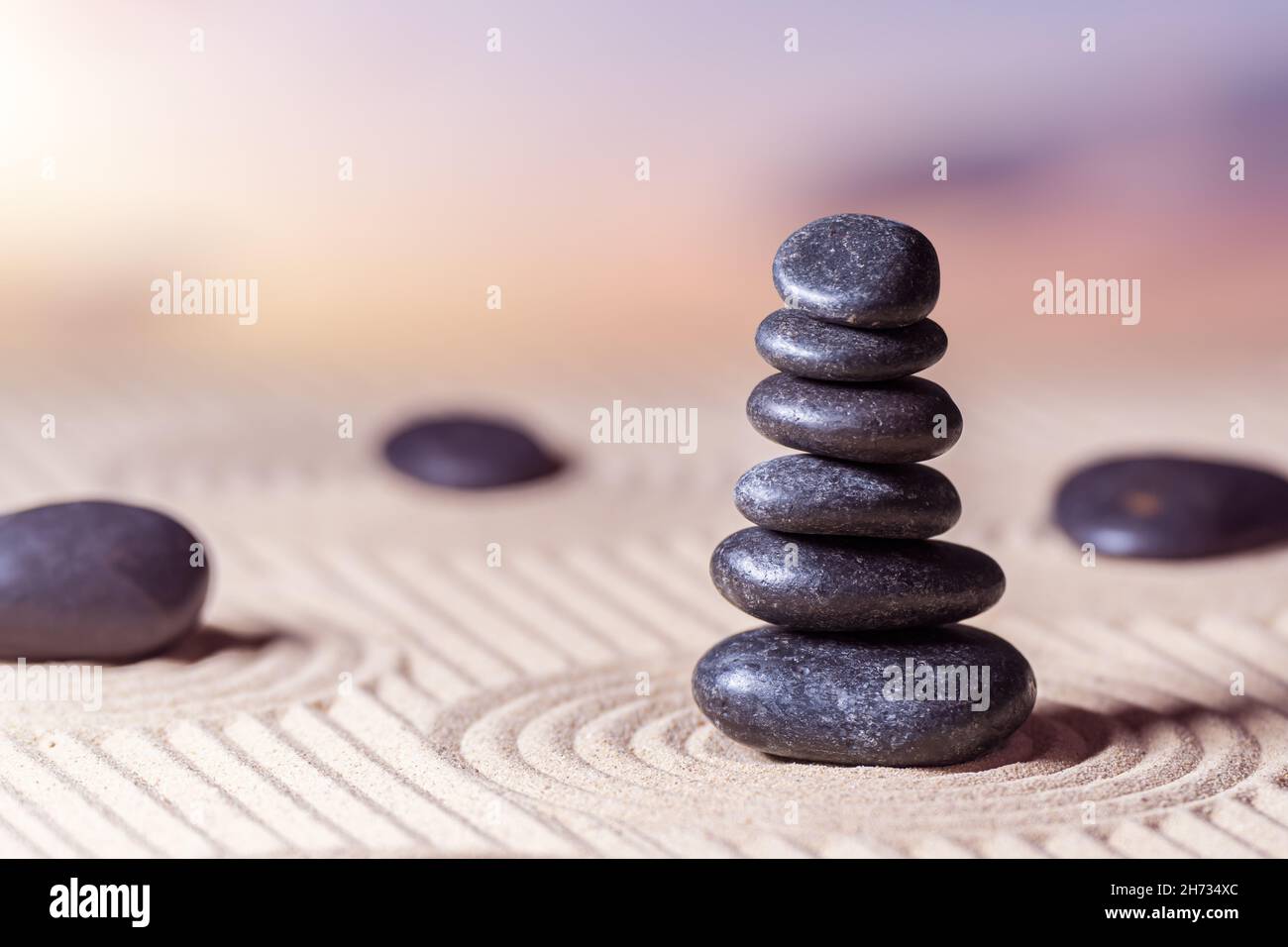Zen garden with stacked stones on sand Stock Photo - Alamy