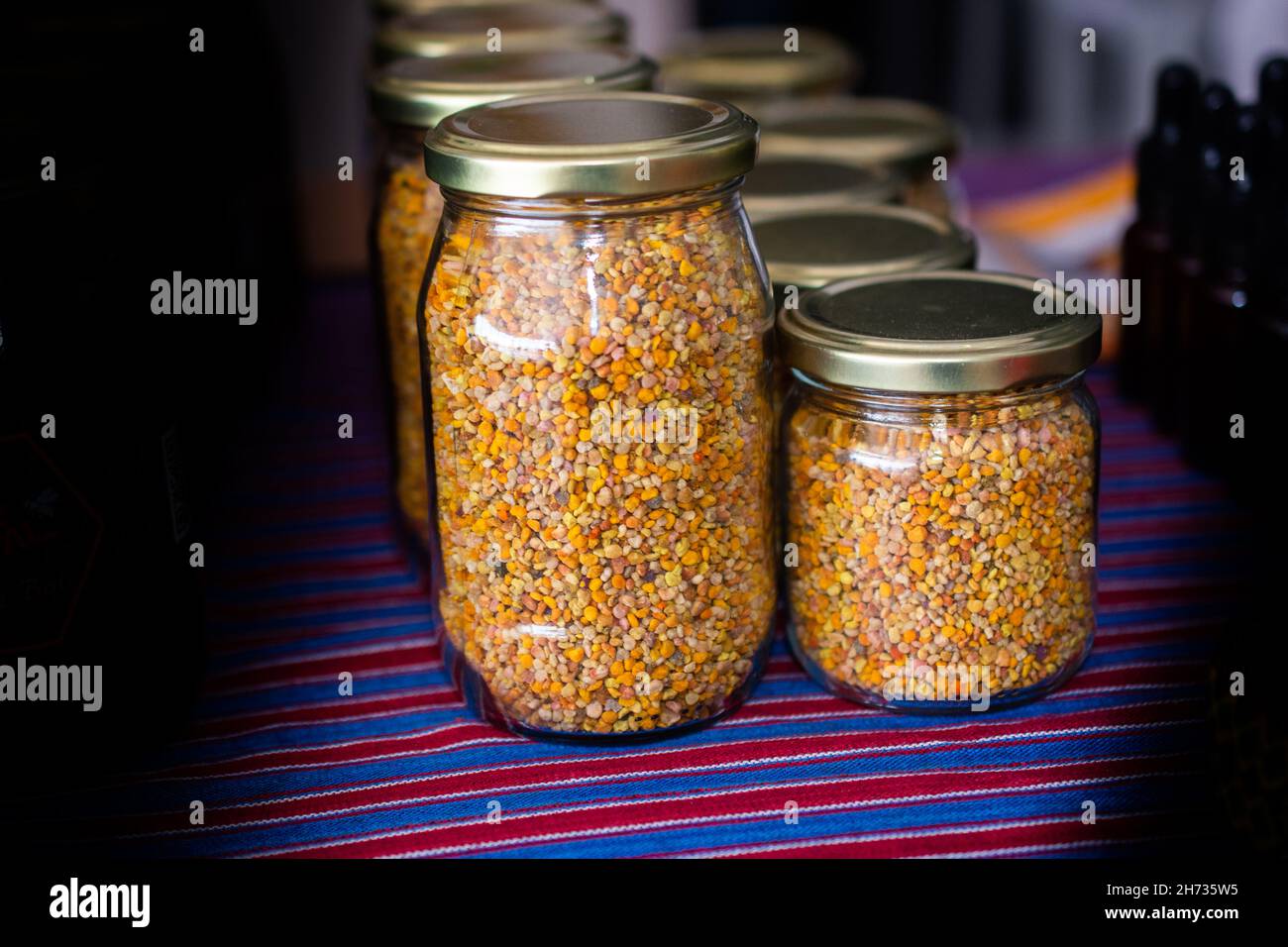 Pollen as healthy organic raw diet food. Raw bee pollen grain in glass ...