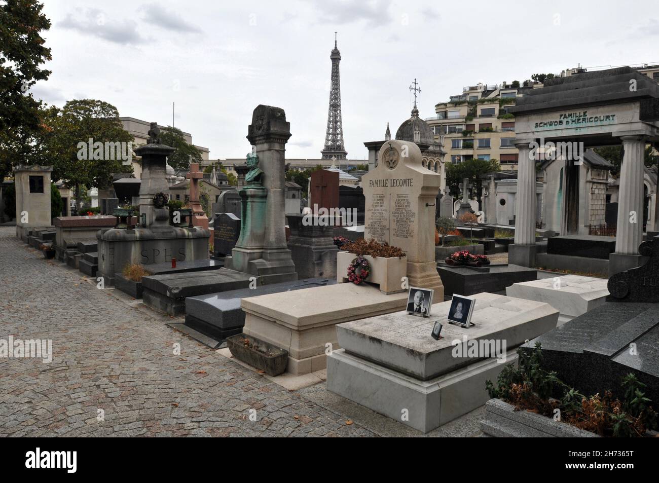 The Eiffel Tower stands in the background beyond rows of graves at the ...