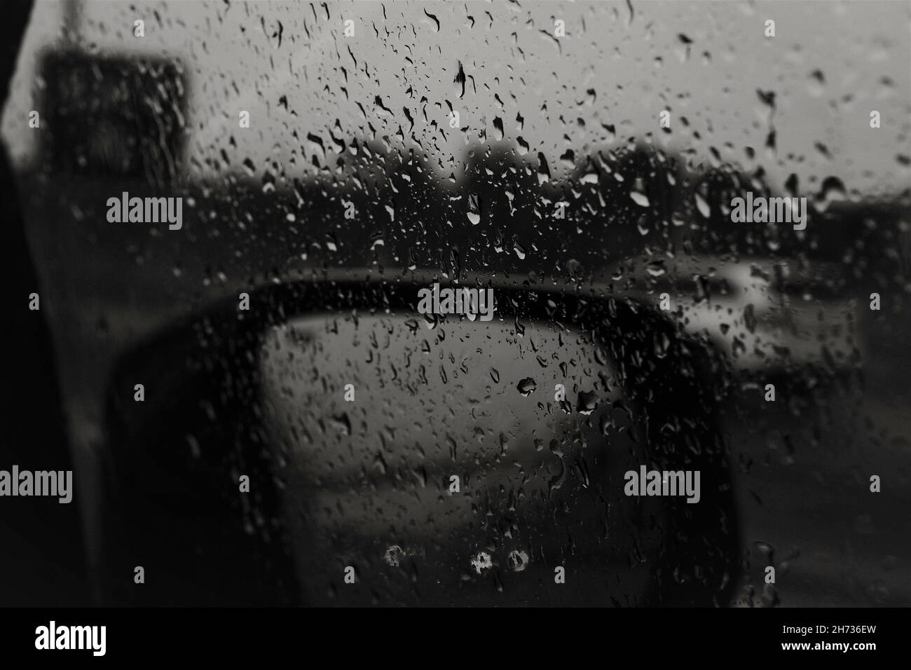 Eerie scenery of raindrops on the car window, grayscale shot Stock ...