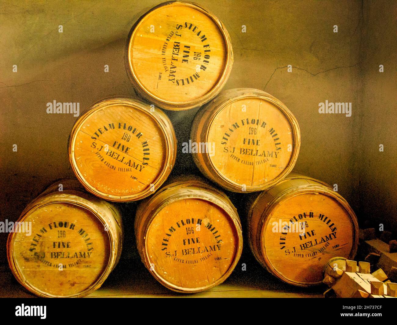 Six wooden flour barrels stamped Steam Flour Mills, stacked in a ...