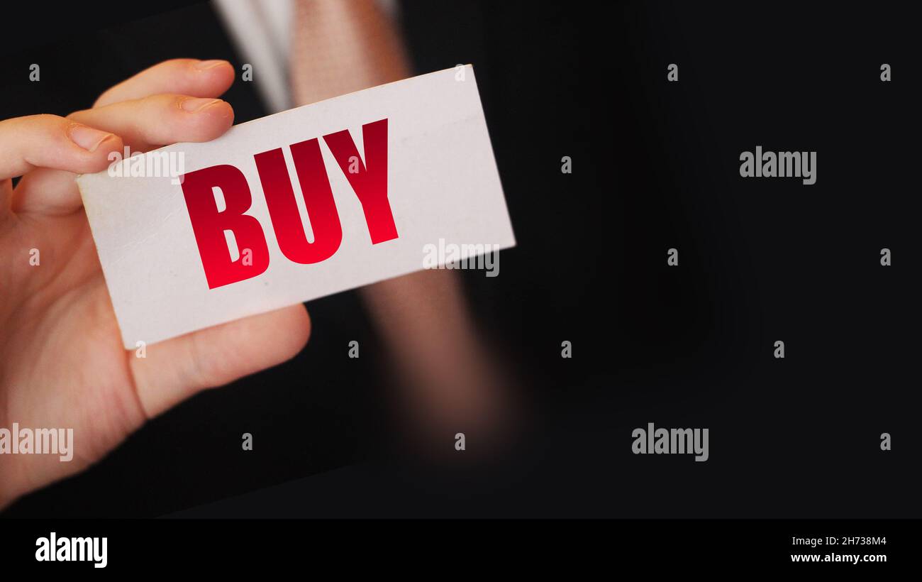 Buy word on the card shown by a businessman. Shopping spending concept ...