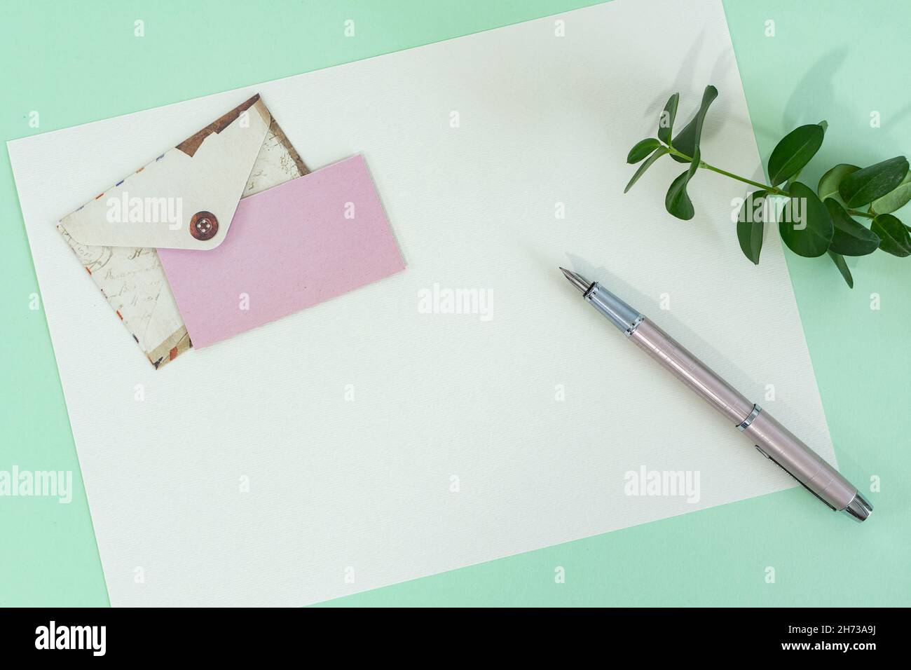 Top view of a sheet of paper with a pen and an envelope on it with copy ...