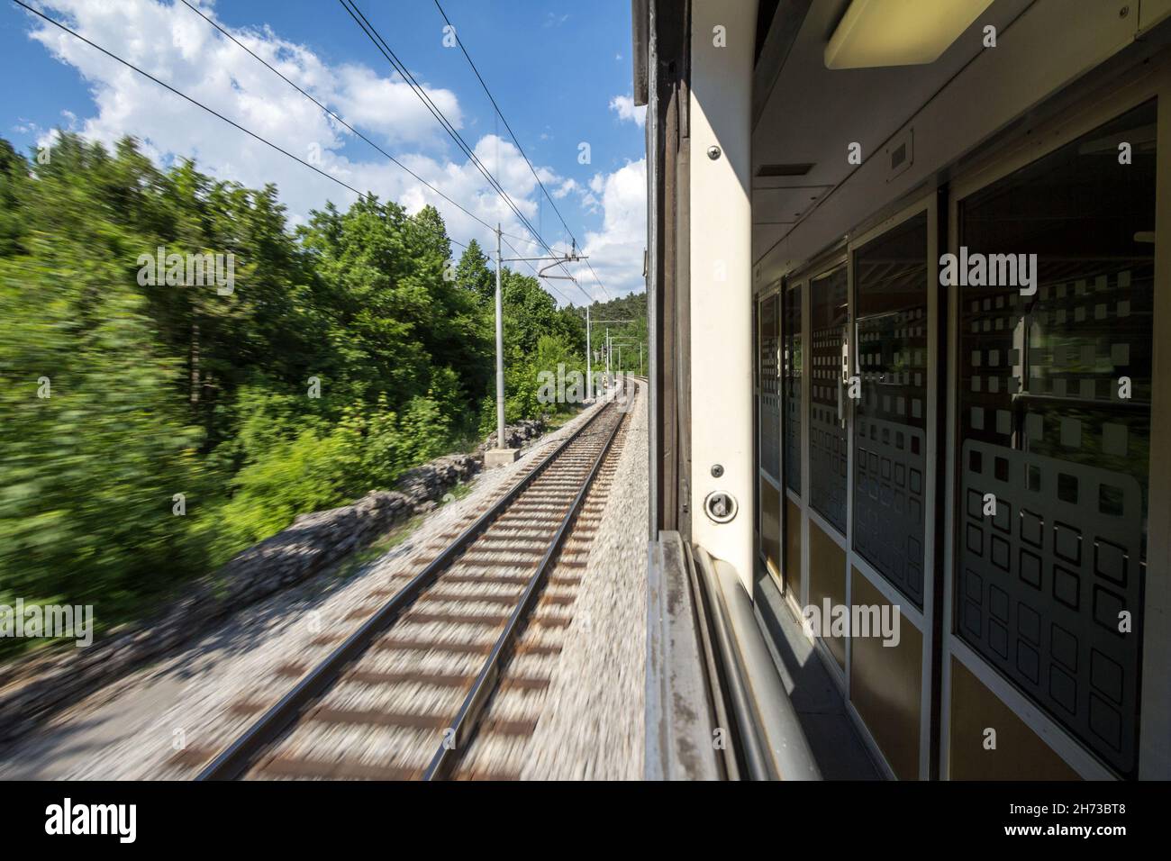 Picture of a passenger train from its interior, with a view from an ...