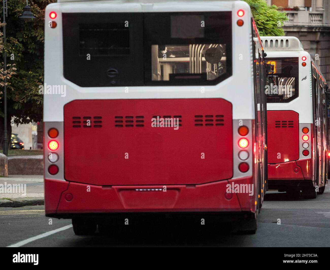 Picture oftwo red buses,urban vehicles, on city services, on stand by ...