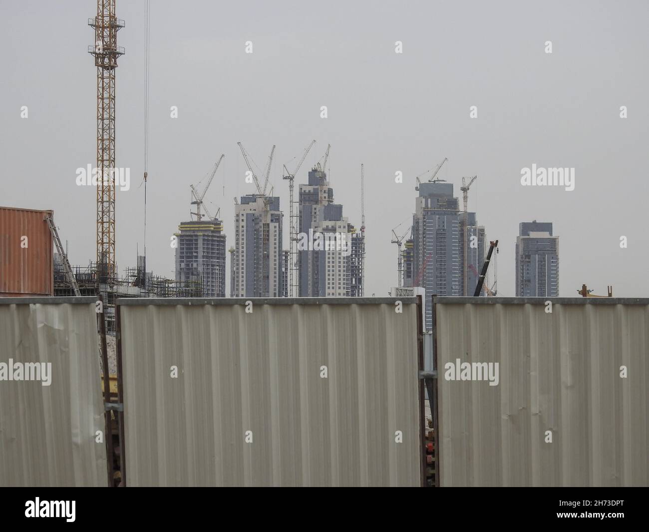 Construction site fence behind which an entire skyline with several ...