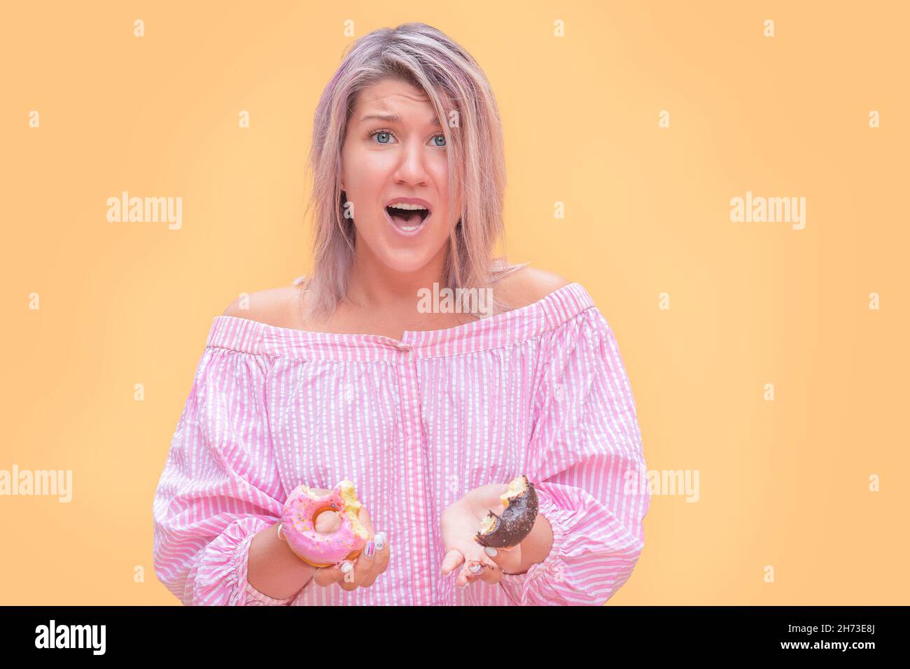 A pretty young woman is surprised how much she ate is not a healthy ...