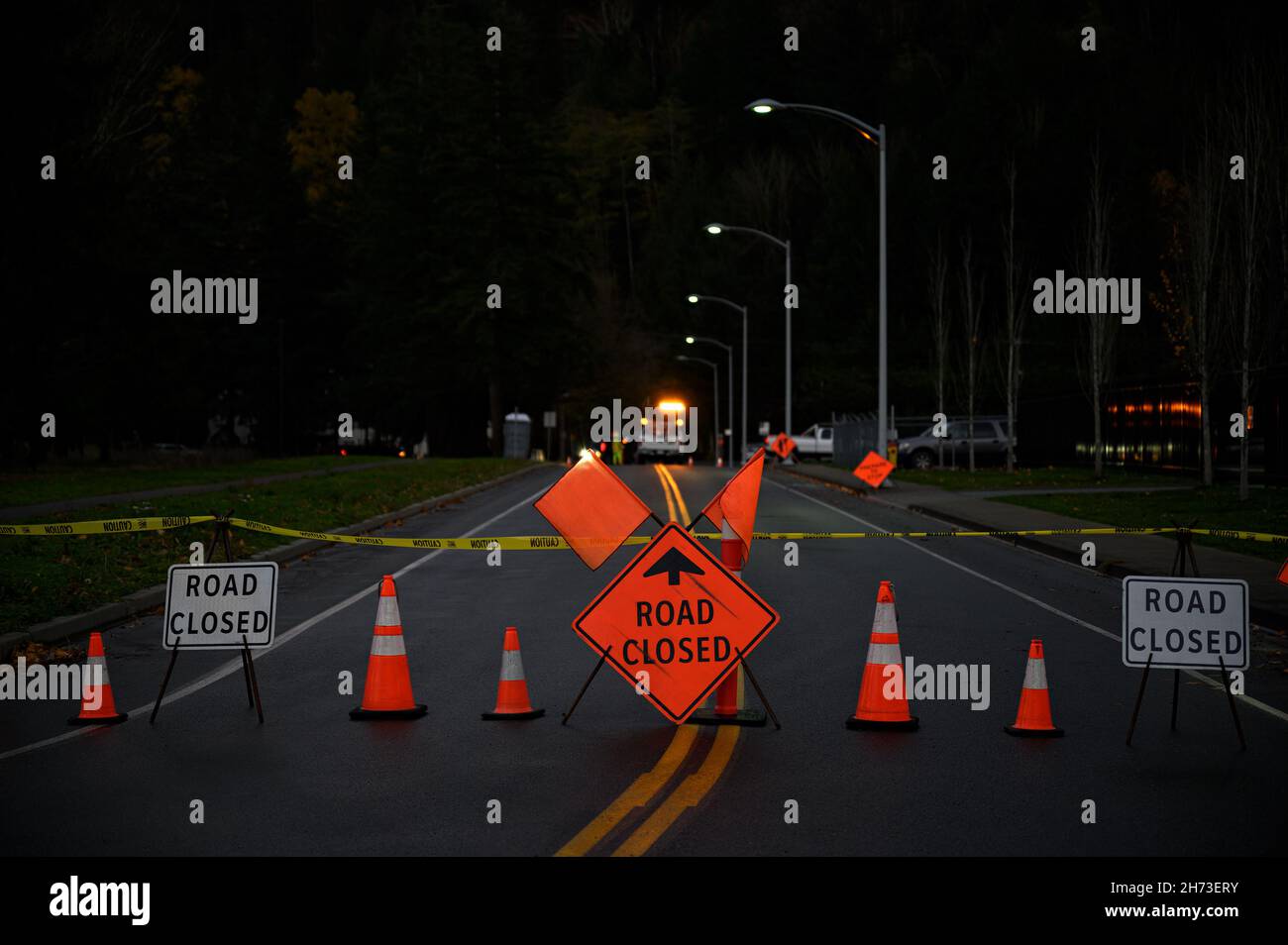 Night photo of a reflective and bright orange construction sign on the ...