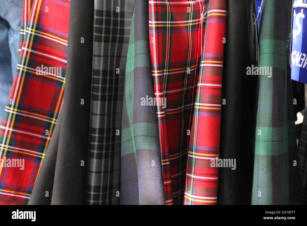 Closeup display of various colourful kilts in red, blue, green, white ...