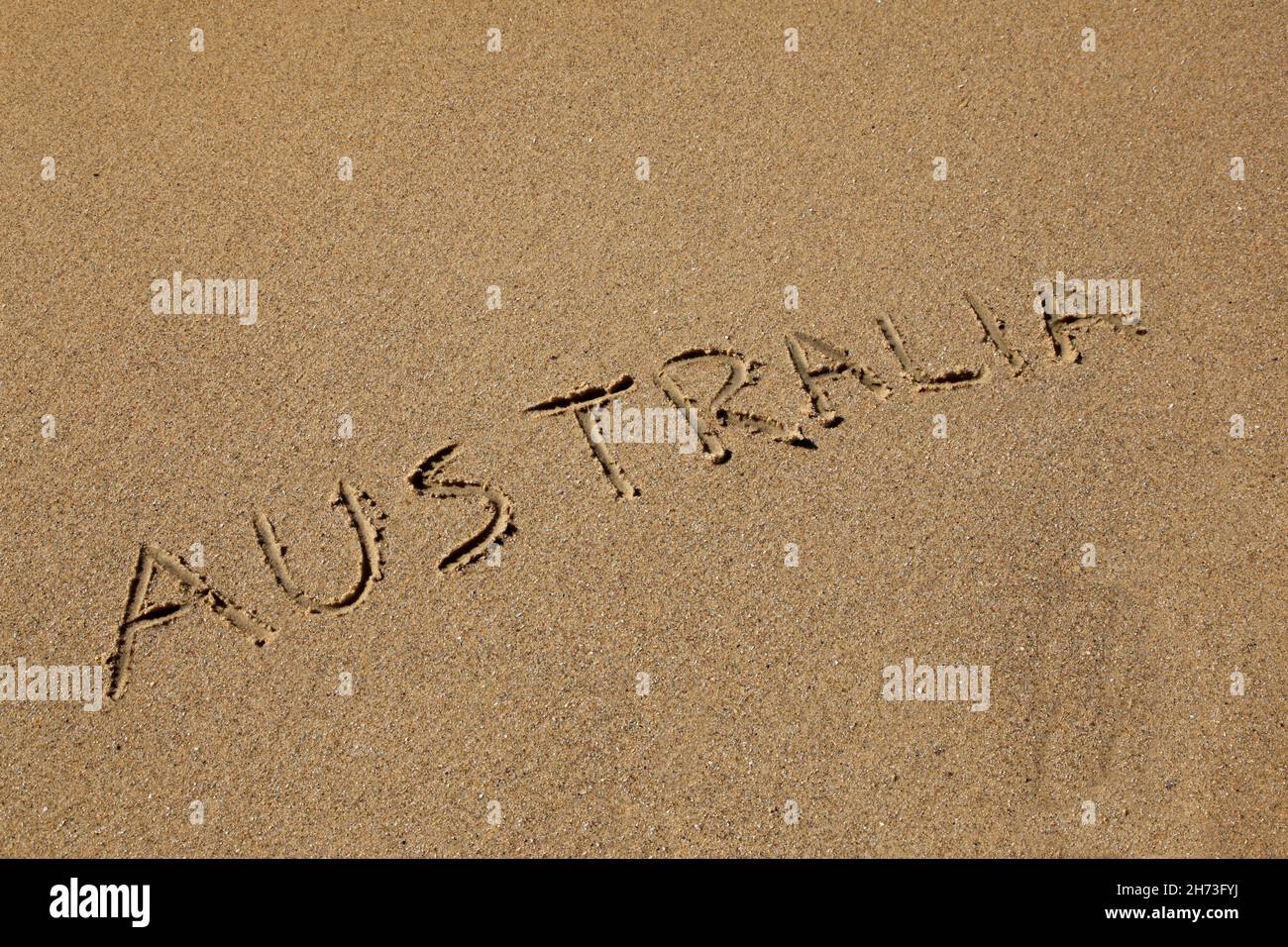 Australia drawn in the sand at the beach on an angle. Australia's ...