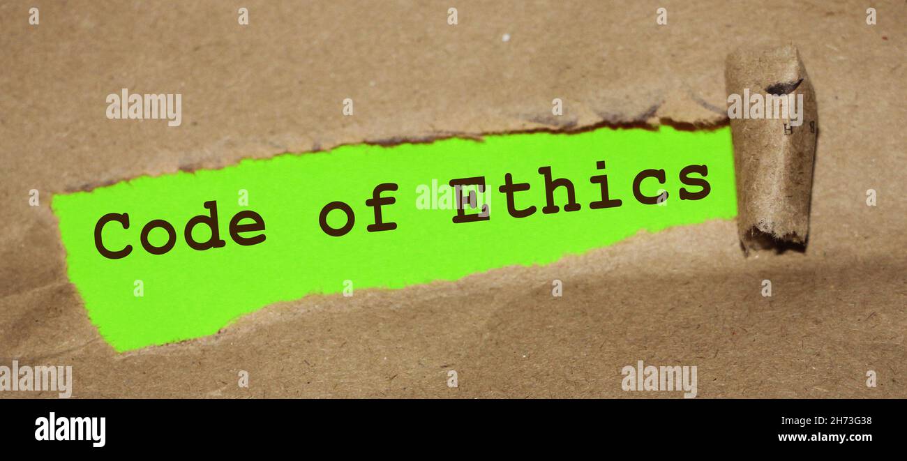 Text appearing behind torn brown envelop - Code of ethics Stock Photo ...