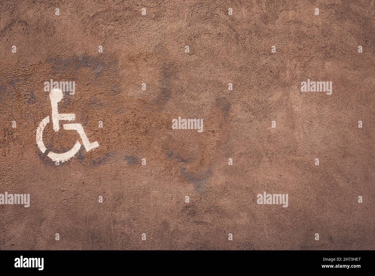 Handicapped sign on an old concrete wall with free space for text Stock ...