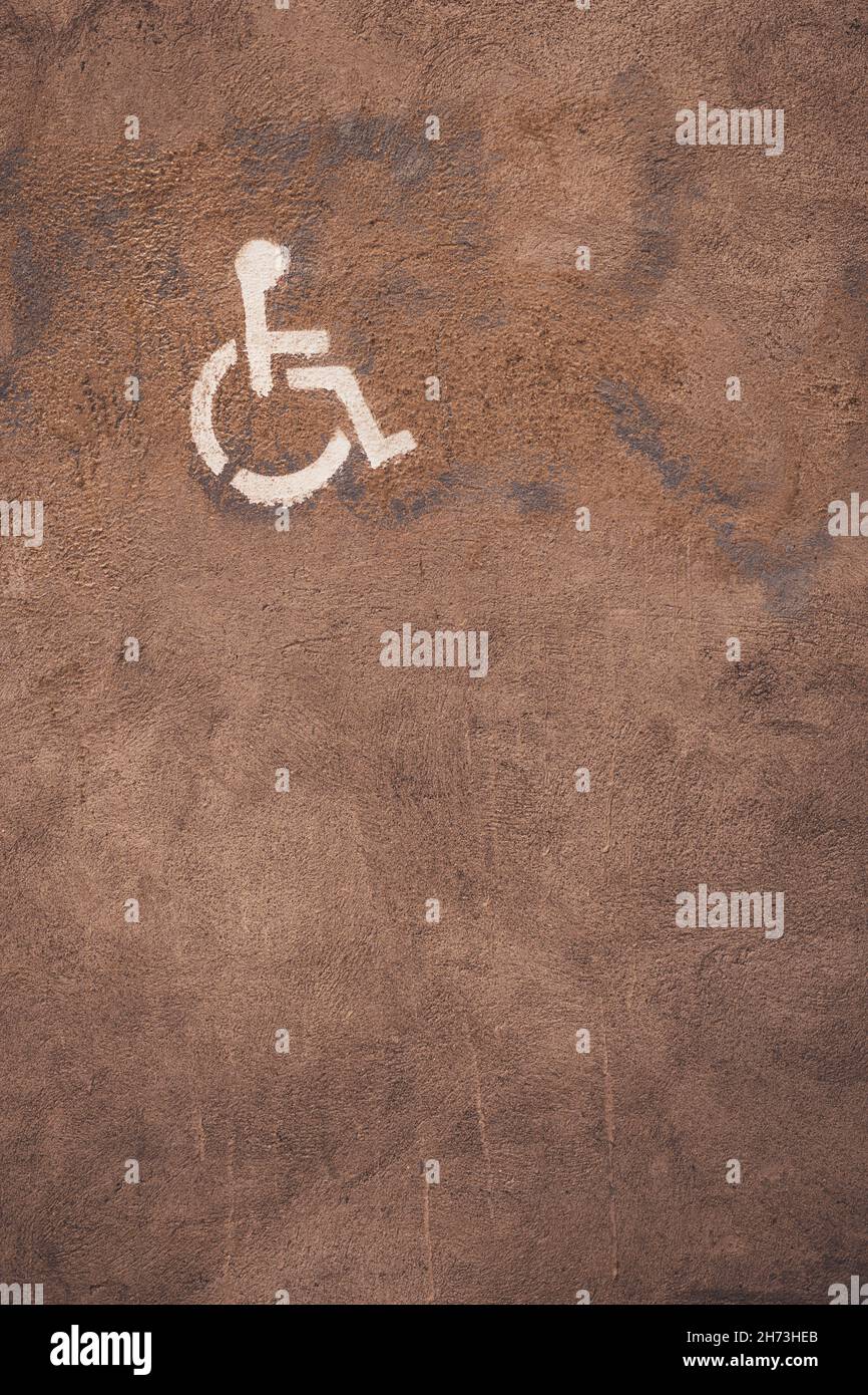 Handicapped sign on an old concrete wall with free space for text Stock ...