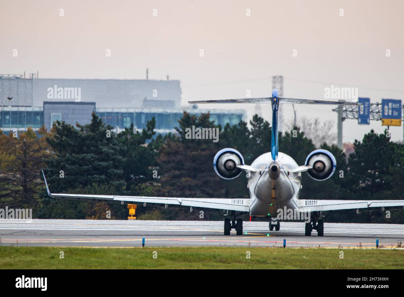 A commercial airplane lining up for takeoff at a large airport in a ...