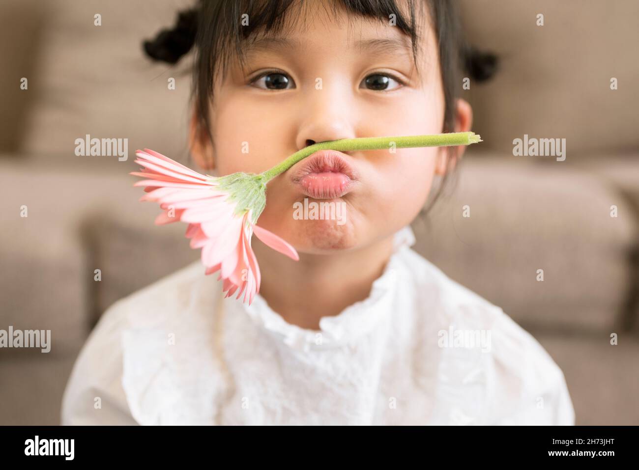 Cute little girl making faces Stock Photo - Alamy