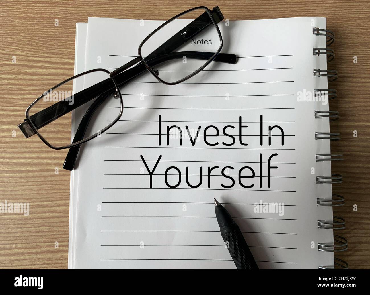 Text on notepad with pen and glasses - Invest in yourself Stock Photo ...