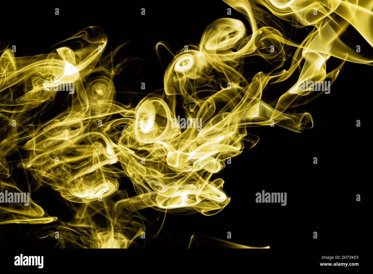 Yellow color abstract smoke on black background Stock Photo - Alamy
