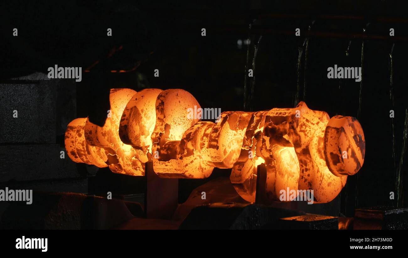 Close up view of hot steel forging process with big mechanical hammer ...