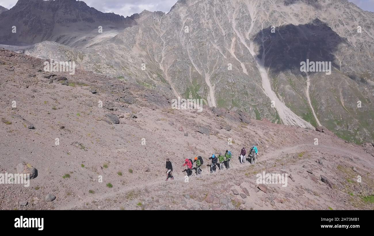 Top view of group of ascending tourists on background of mountain ...