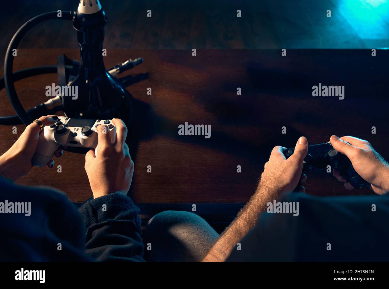 friends playing console video games. controller in hands closeup. neon ...