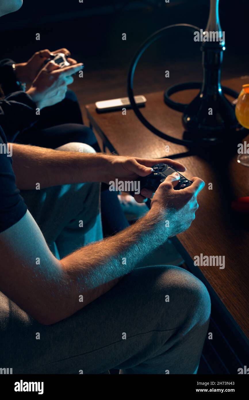 friends playing console video games. controller in hands closeup. neon ...