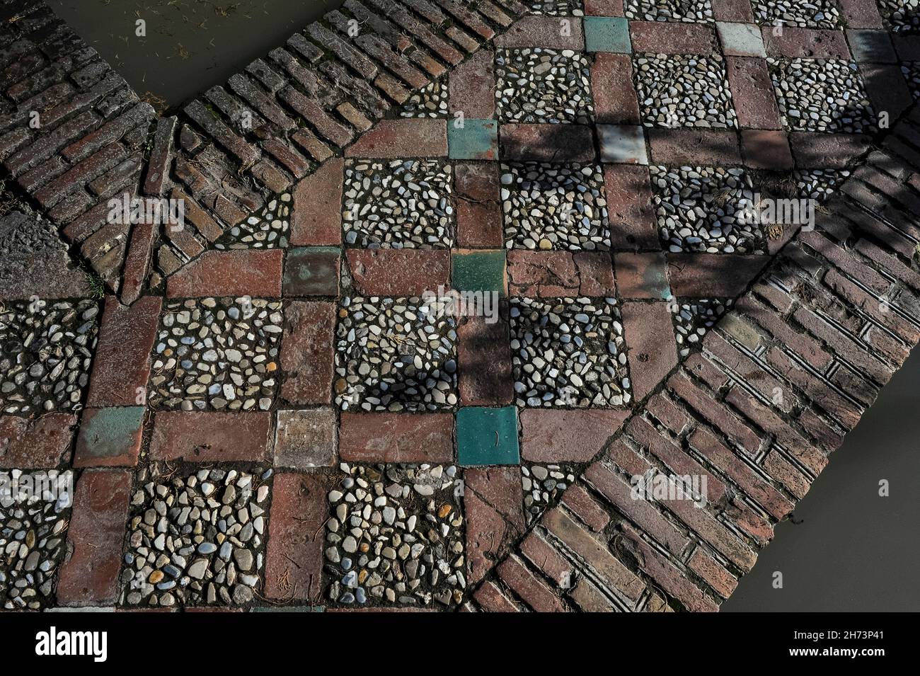 River pebble squares, weathered terracotta and turquoise tiles ...