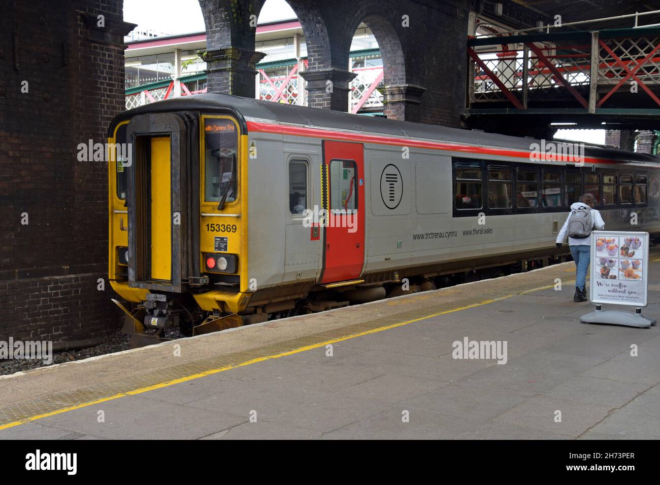 Passengers catching a Transport for Wales Class 153 Spuer Sprintert DMU ...