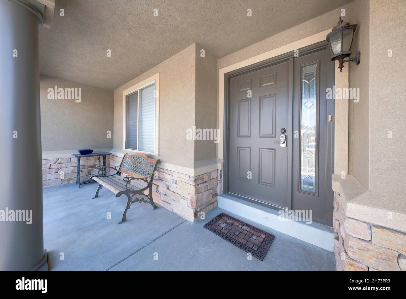 Front door exterior of a house with bench and table on the side Stock ...