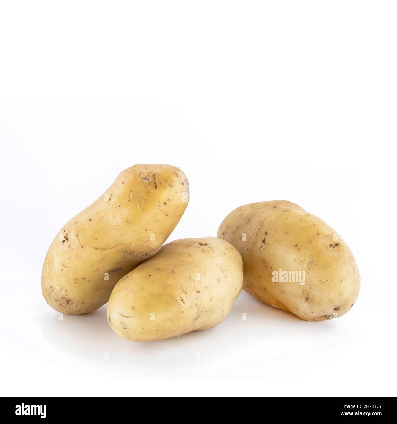 Three potatoes isolated on white background. Raw food. Peel details ...