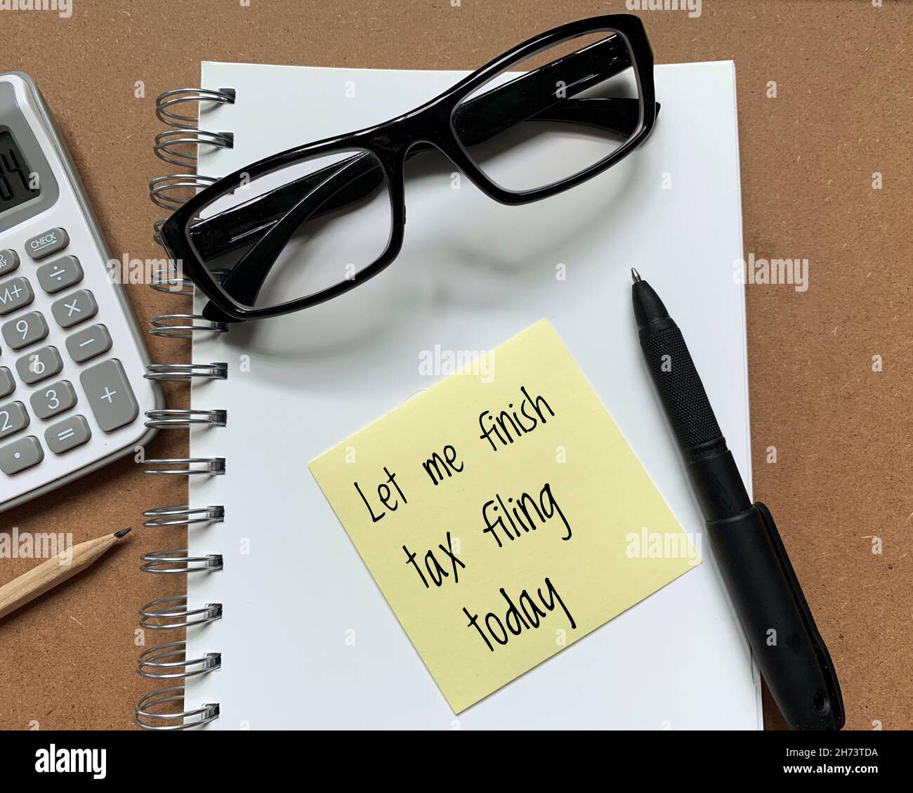 Image showing a message written on sticky note - Let me finish tax ...