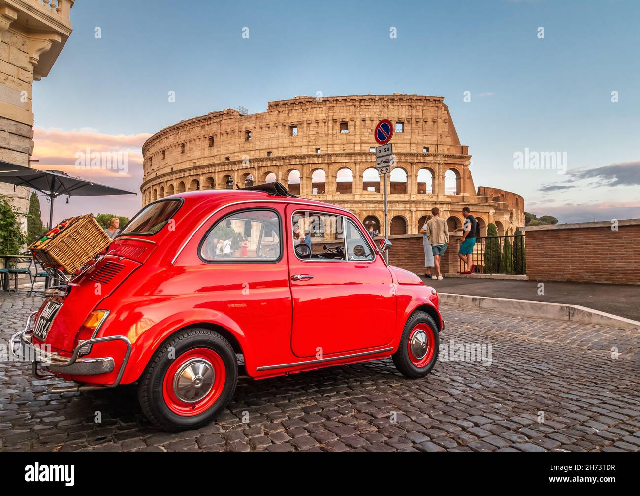 Little red old Fiat 500 near coliseum at sunset with picnic basket on ...