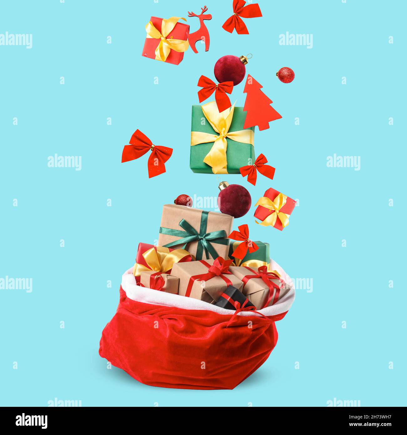 Santa Claus bag with falling gifts and Christmas decorations on blue ...