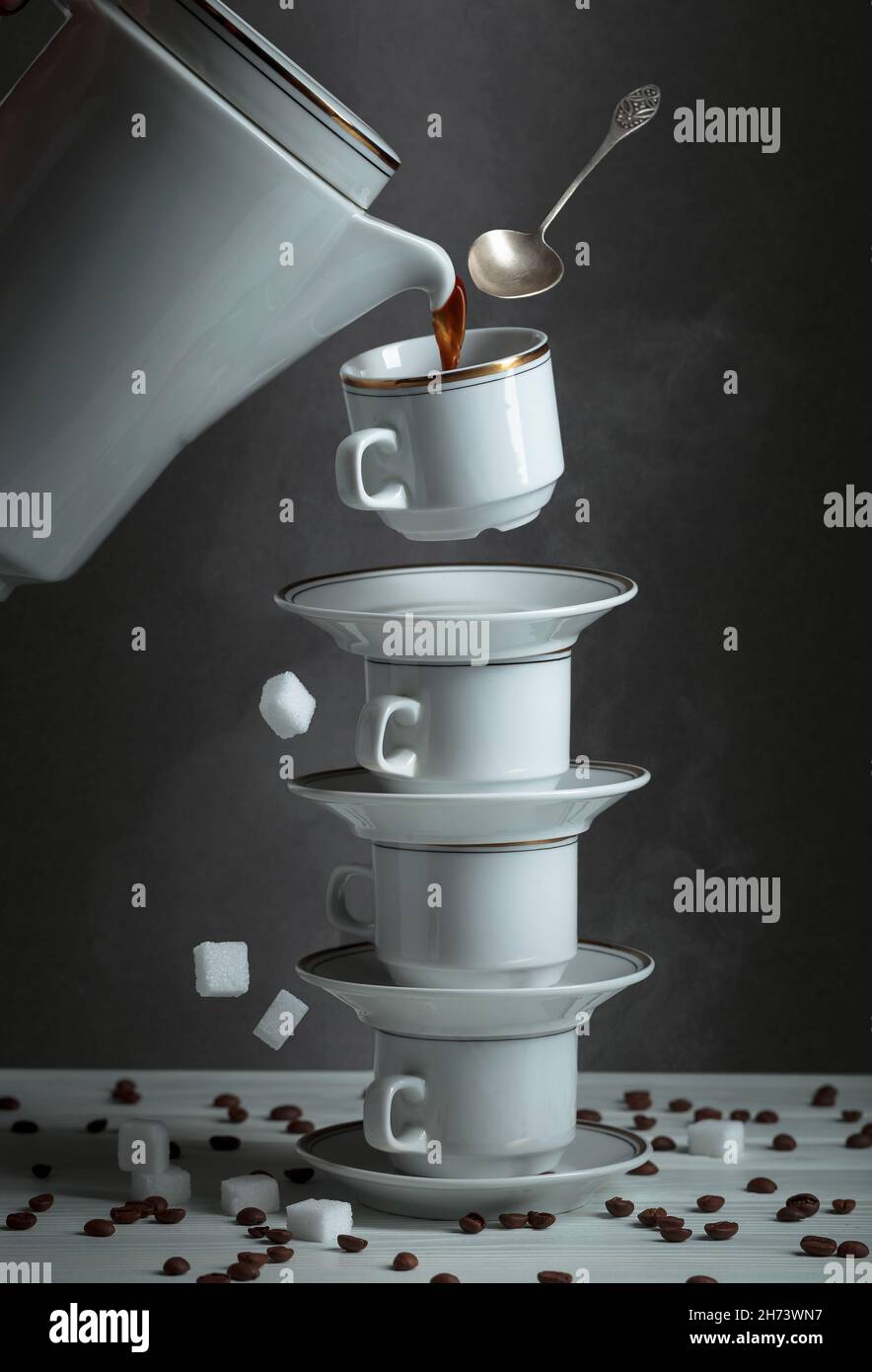 Coffee is poured into a falling coffee cup. Concept of the theme of ...