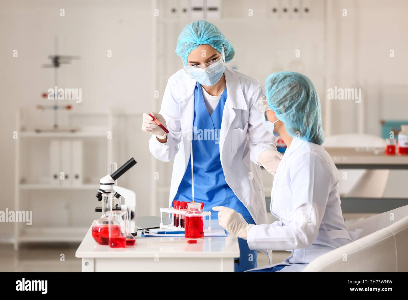 Scientists working with sample in laboratory Stock Photo - Alamy