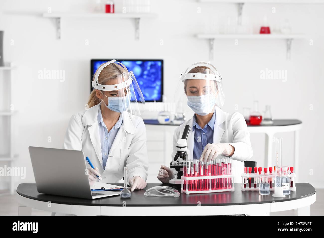 Scientists working with sample in laboratory Stock Photo - Alamy