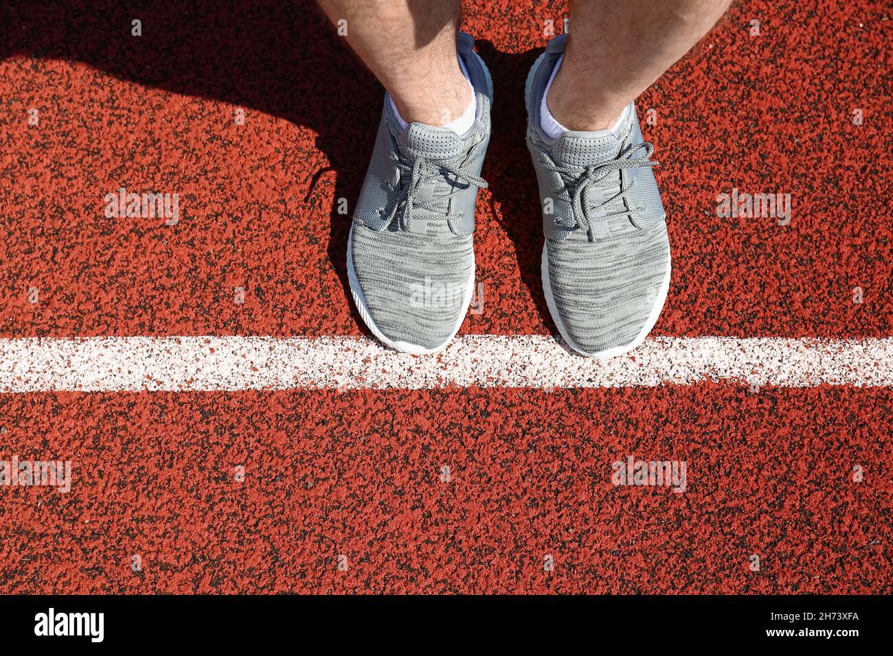Man on start line in stadium Stock Photo - Alamy