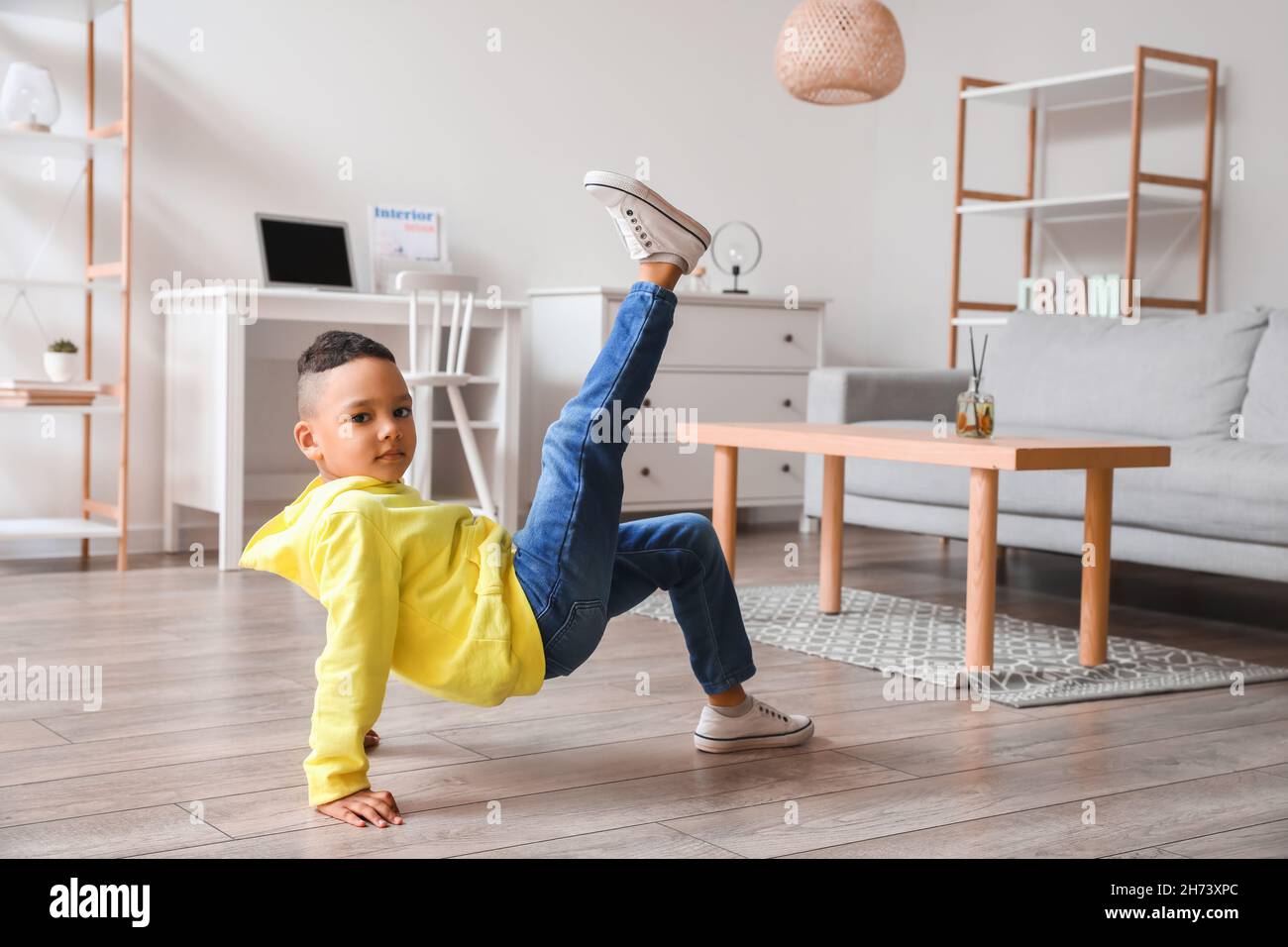 Cute African-American boy dancing at home Stock Photo - Alamy