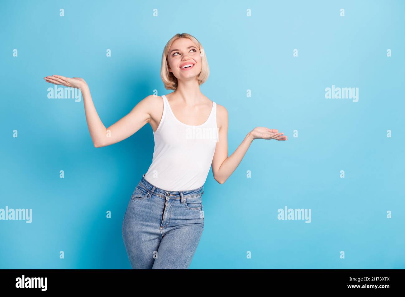 Photo of adorable satisfied lady raise arms palms look interested empty ...