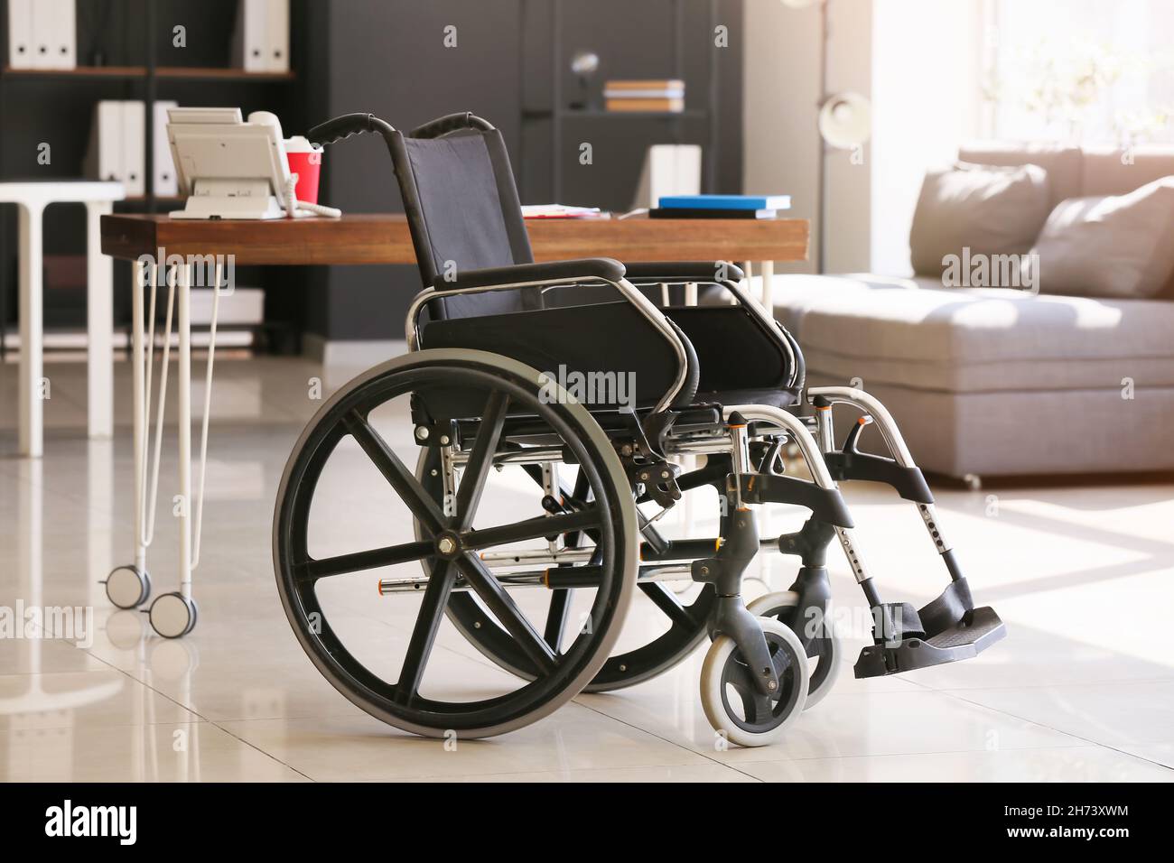 Empty wheelchair in modern office Stock Photo - Alamy