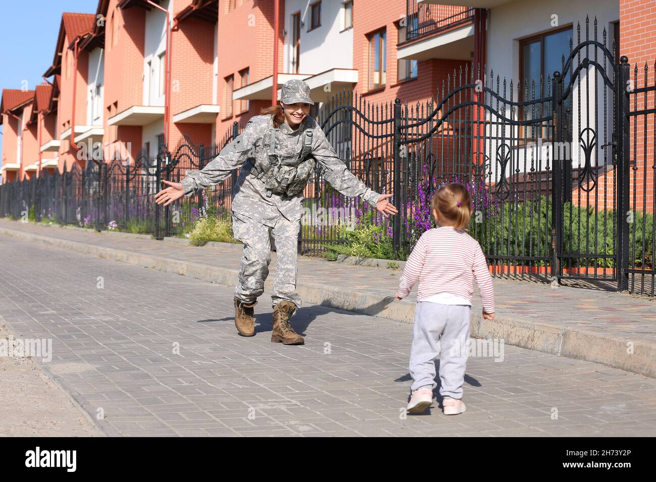 Baby girl meeting her military mother outdoors Stock Photo - Alamy
