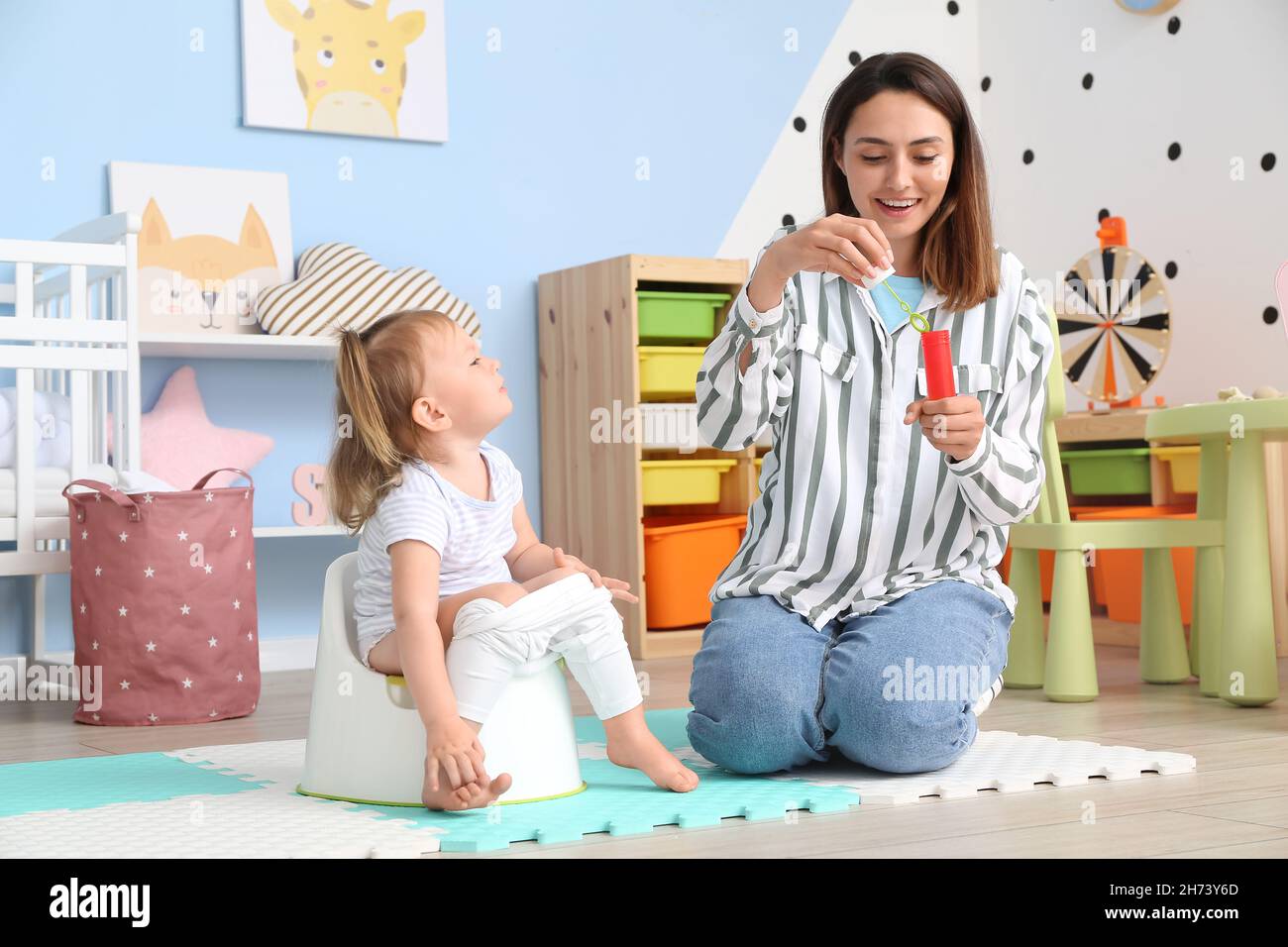 Mother potty training her little daughter at home Stock Photo - Alamy
