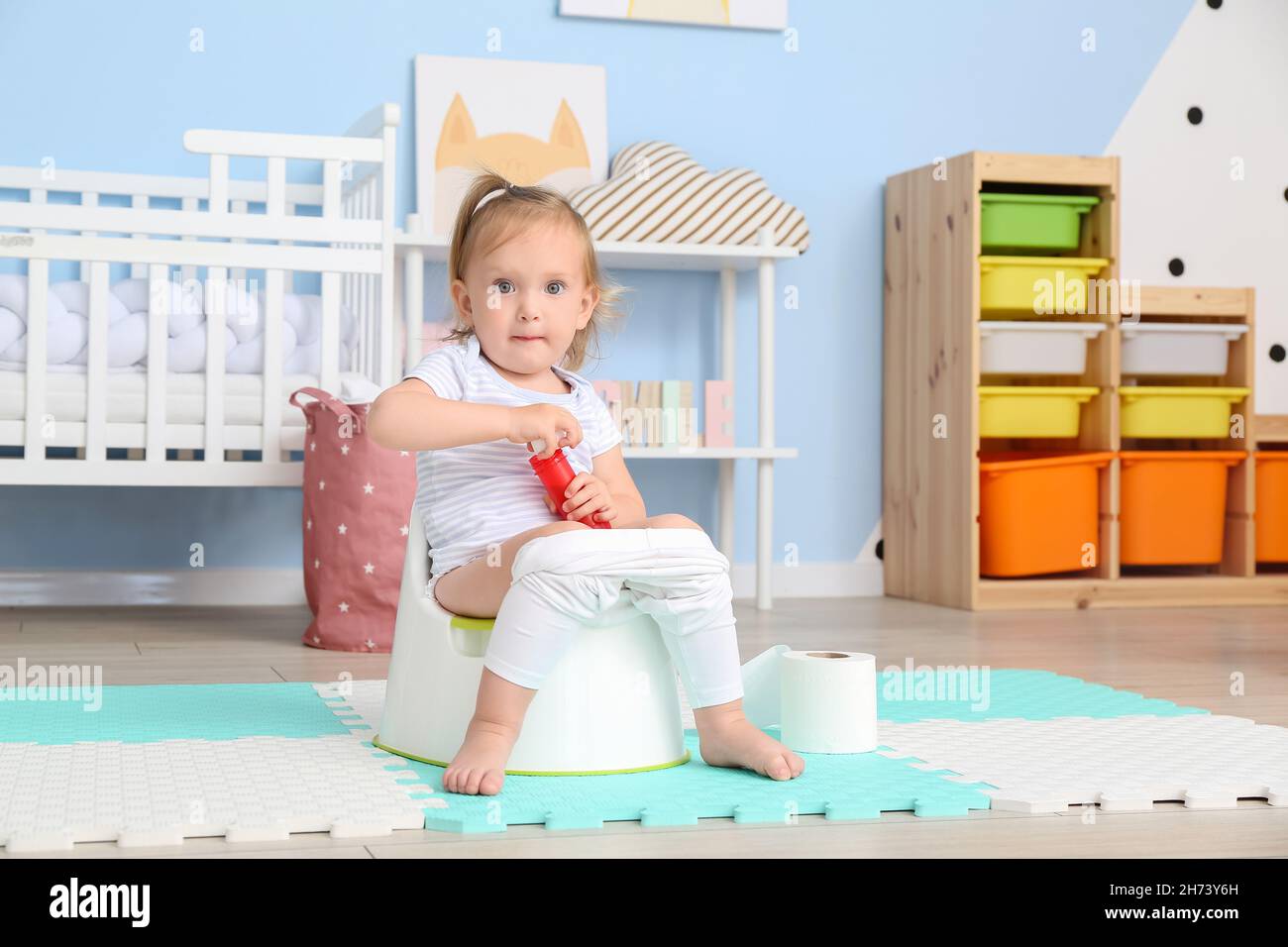 Cute baby girl sitting on potty at home Stock Photo - Alamy