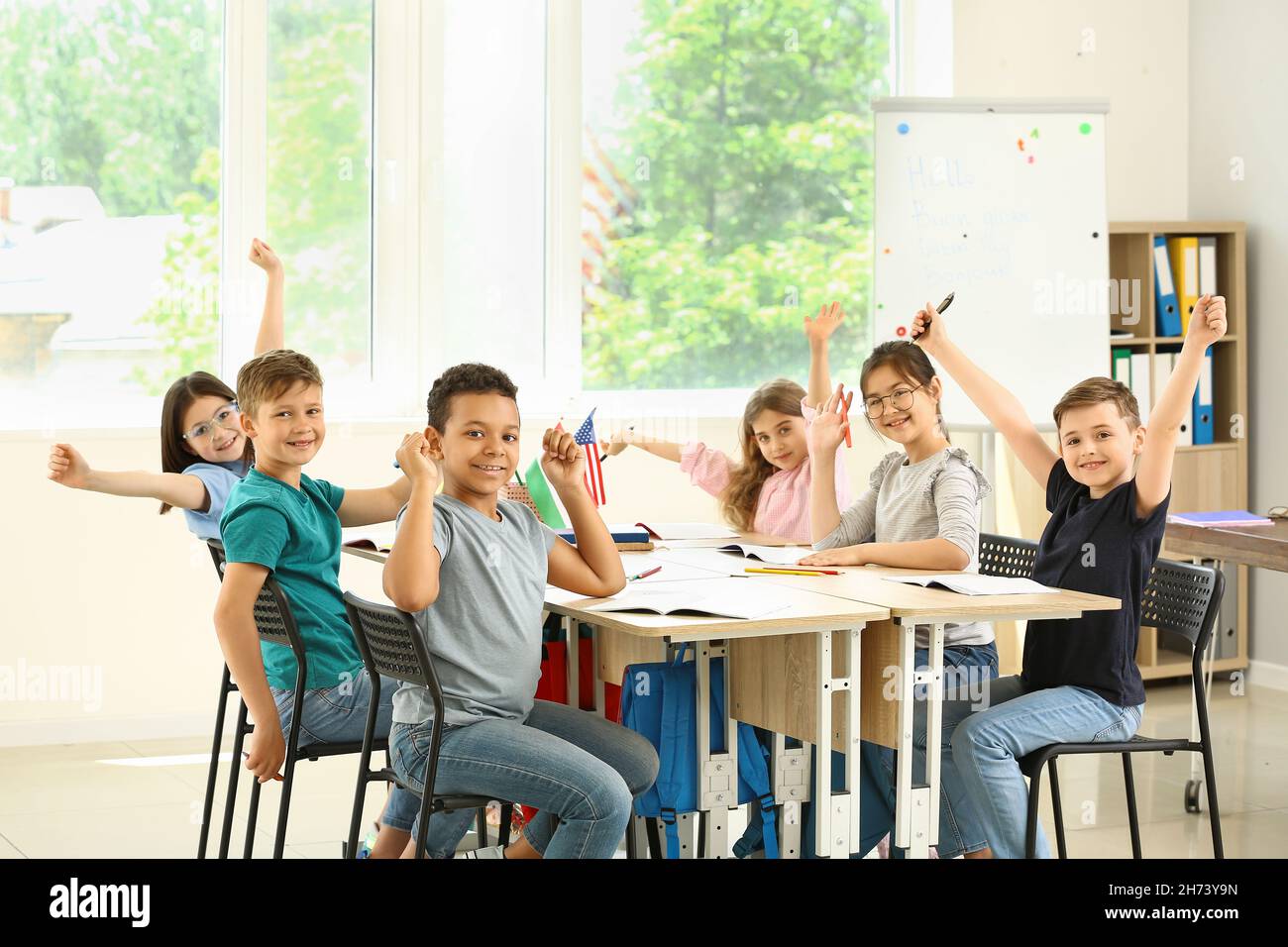 Happy children taking classes at language school Stock Photo - Alamy