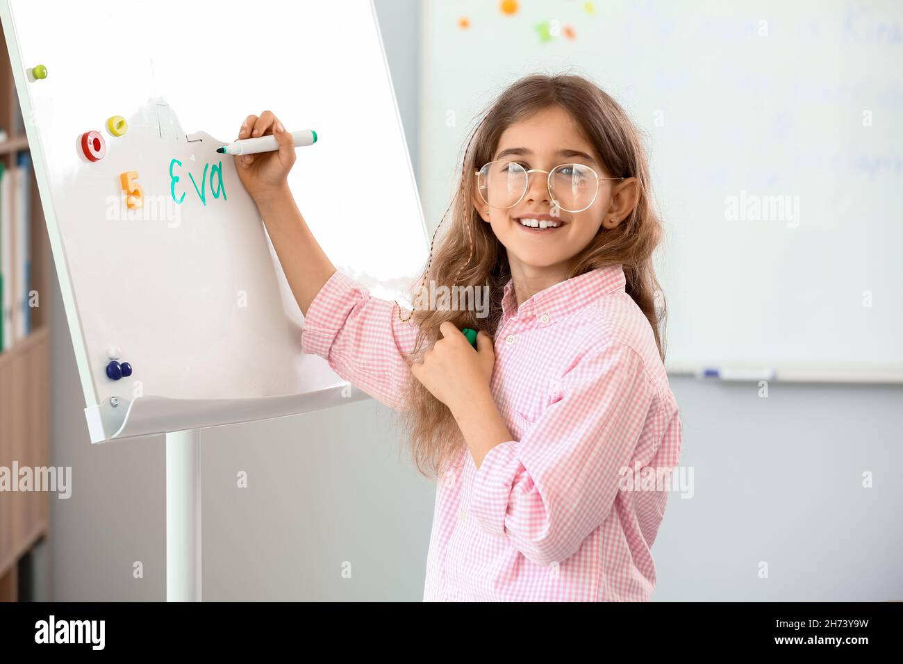 Pupil writing on blackboard during lesson at language school Stock ...