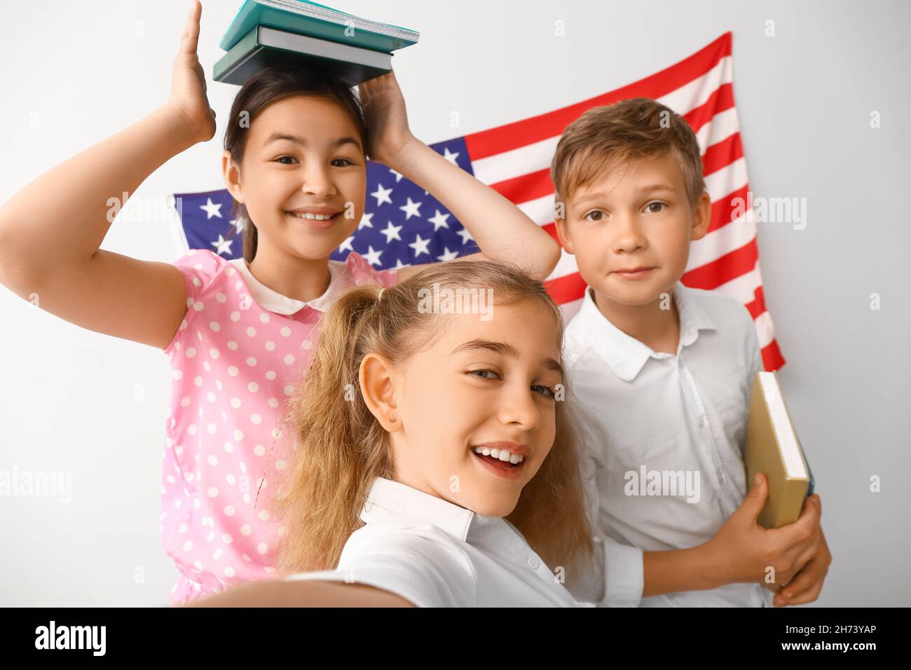 Pupils of language school near light wall with USA flag Stock Photo - Alamy